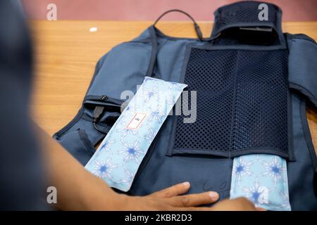 Medical worker prepare the newly supplied ice vest at a temporary ...