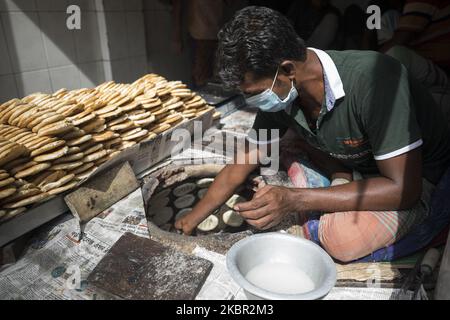 Bakers make Bakarkhani at a street side shop in old Dhaka on June 11 ...