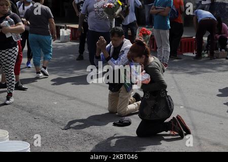 Believers of Santa Muerte, visit their temple on their knees located in ...