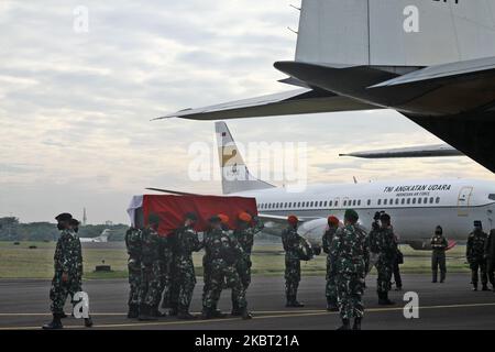 A military honor guard dressed in UN task force carry the photograph of ...