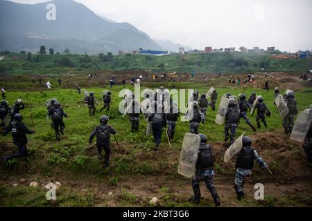 Nepalese policemen disperse demonstrators during a protest that turned ...