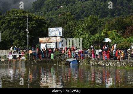 Nepalese devotees lined up to offer ritual prayer towards Nag or Snake ...