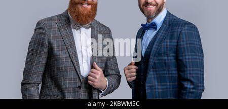 cropped view studio shot of gentlemen wearing tux. elegant gentlemen in ...