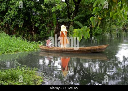 Citizens ride on a boat through flood water at Lowland area of the ...