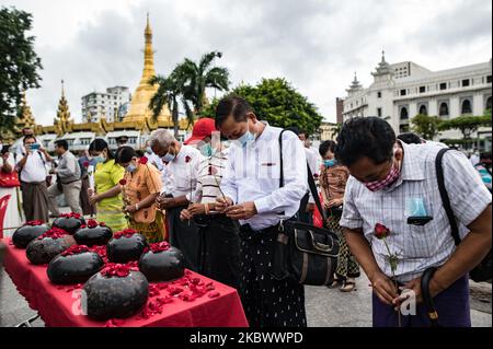 People lay roses during a ceremony to mark the 32nd anniversary of the ...