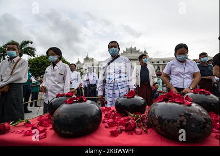 People lay roses during a ceremony to mark the 32nd anniversary of the ...