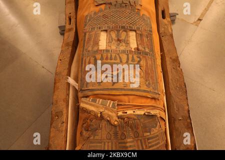 A 2400-year old mummy kept out of its box at a safe place after rain ...