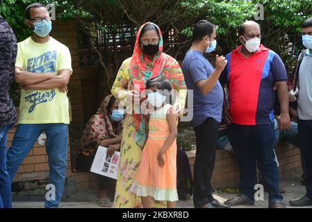 Residents wait outside the Mugda Medical College and Hospital for their ...