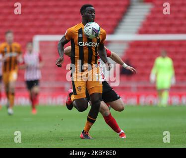 Josh Emmanuel of Hull City in action with Denver Hume of Sunderland ...