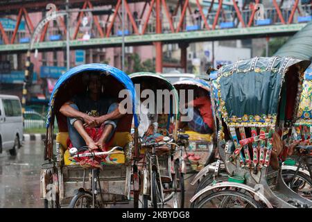 People passing their idle time on a street in Dhaka, Bangladesh on ...