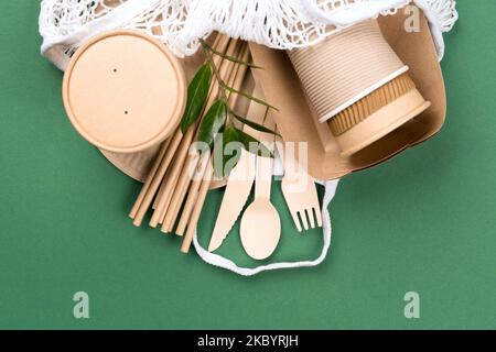 Paper utensils in white cotton bag over light green background - banner ...