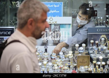An Iranian trader adjusts a shop window at his dress shop in a shopping ...