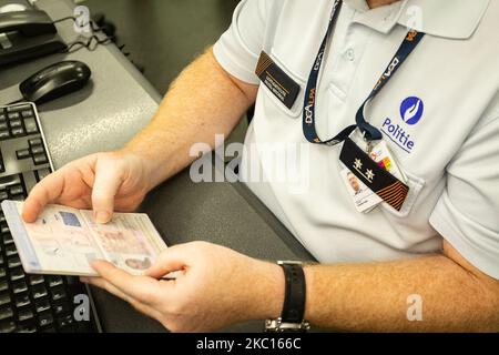 Illustration picture shows a customs officer performing a passport ...