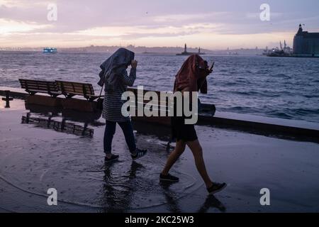 People run from heavy rainfall in Istanbul, Turkey on October 19, 2020 ...