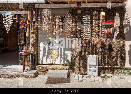 Storefront of souvenir store, with hanged handmade crafts made of sea ...