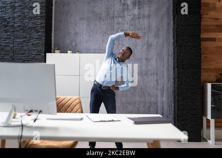 Arms Stretch Exercise Standing Near Desk In Office Stock Photo - Alamy