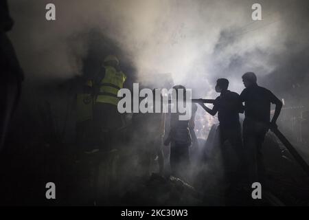 Firefighters work to extinguish a fire that broke out at Wang Fuk Court ...