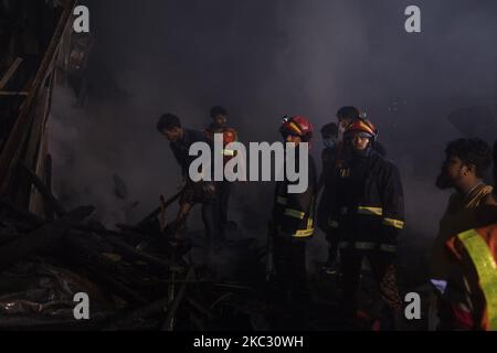 Residence and firefighters work to extinguish a fire that broke out in ...