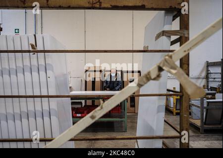 A worker of the Italian company Desmon assembling a part of a ...