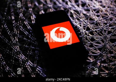 In this photo illustration, the Vodafone logo is seen displayed on a ...