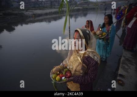 A Nepalese Devotee offering rituals towards the sun god on the fourth ...