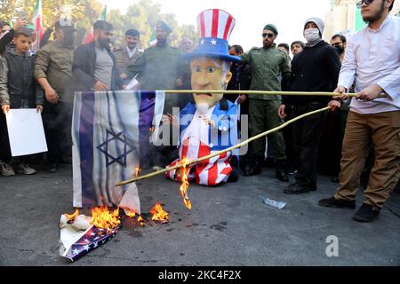 Iranian demonstrators burn representations of the U.S. and Israeli ...