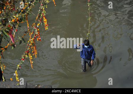 A Nepalese devotee tighten religious rope consists of flower, fruits ...