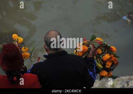 Nepalese devotees tighten religious rope consists of flower, fruits and ...