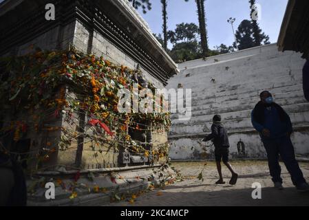 A Nepalese devotee tighten religious rope consists of flower, fruits ...