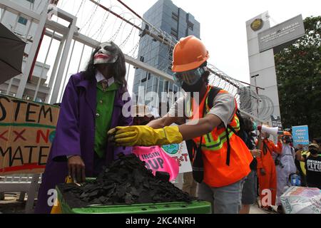 Environmental activists take a theatrical action during a demonstration ...