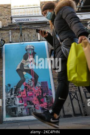 A woman walks by the mural '50 FT HEROES' by the Irish artist Shane ...