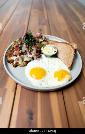 A vertical shot of a breakfast with vegeterian salad, sliced bread and ...