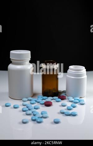 Red pills spilled around a pill bottle. Medicines and prescription ...