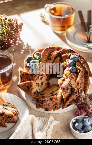 Sliced Blueberry Bundt Cake decorated with berries and tea, sunny ...