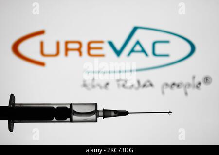 Medical syringe is seen with Bayer logo displayed in the background in ...