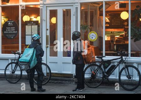 Food delivery couriers await orders outside the Elephant and Castle ...