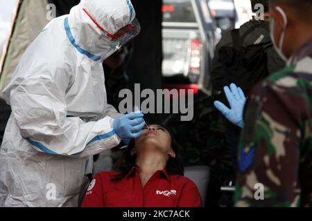 Medical team from Indonsesian Navy take a swab test for Covid-19 from ...