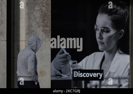 A man walks by a geant poster 'Discovery' in Dublin city center during ...