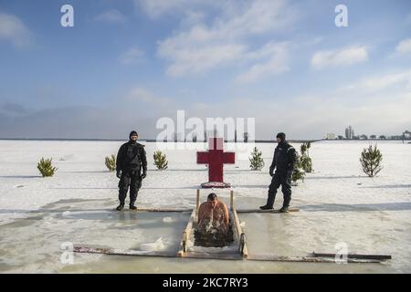 An Orthodox believer bathes in the icy water during celebrations of the ...