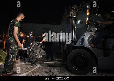 Joint SAR officers load the wreckages of crashed Sriwijaya Air flight ...