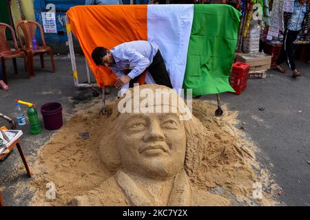 An artist gives final touches to a sand sculpture of Netaji Subhas ...