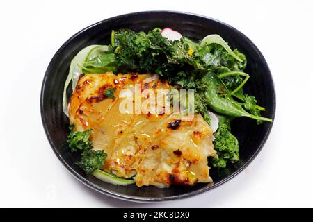 miso paste glazed chicken mixed vegetable and lettuce salad in a bowl ...