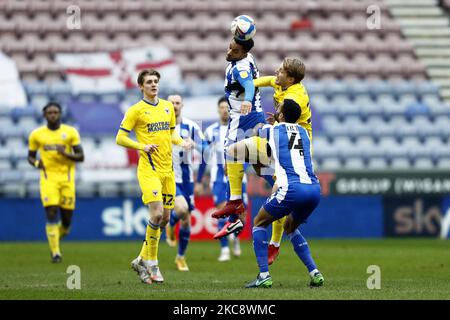 Wimbledons Joe Pigott battles with Wigans Jamie Proctor during the Sky ...