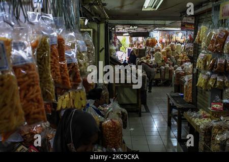 A vendor wearing a face mask to help curb the spread of the coronavirus ...