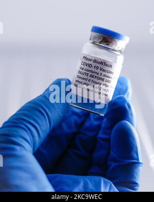 In this photo illustration a vial of Pfizer-BioNtech COVID-19 vaccine ...