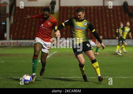 Hayden White of Walsall battles with Barrow's Scott Quigley during the ...
