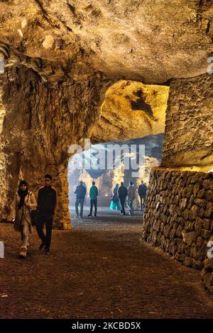 Tourists walk through the Caves of Hercules (Grottes d'Hercule) in ...