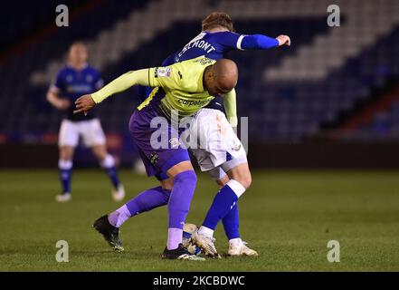 Jake Caprice of Exeter City tussles with Oldham Athletic's Conor ...