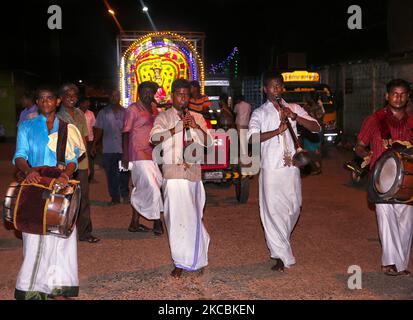 Tamil Hindu musicians playing the nadaswaram and thavil escort an idol ...