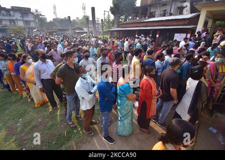 People stand in queue to cast their votes at a polling center during ...